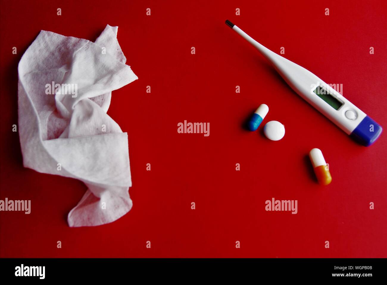 Spring flu, cold - pills and a thermometer on a red background - no ...