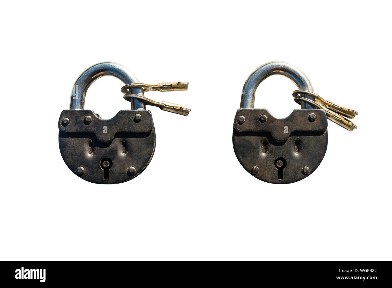 Two closed padlocks lying side by side with keys on padlocks, isolated ...