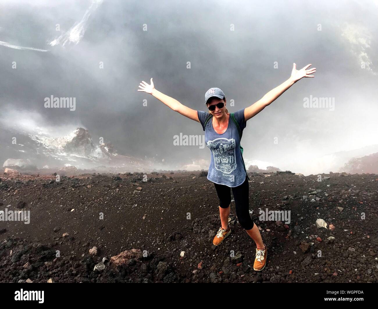 Person standing in front of volcano hi-res stock photography and images ...