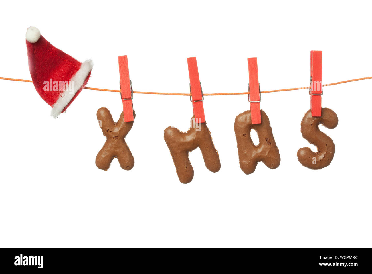 Chocolate Xmas Text With Santa Hat Hanging On Clothesline Against White ...