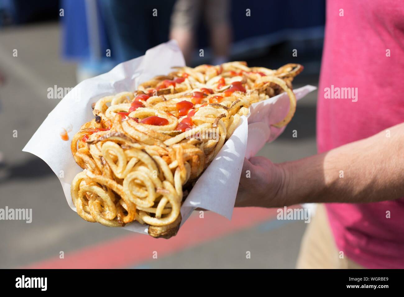 A man holding a brick of fries, at the Oregon State Fair in Salem ...