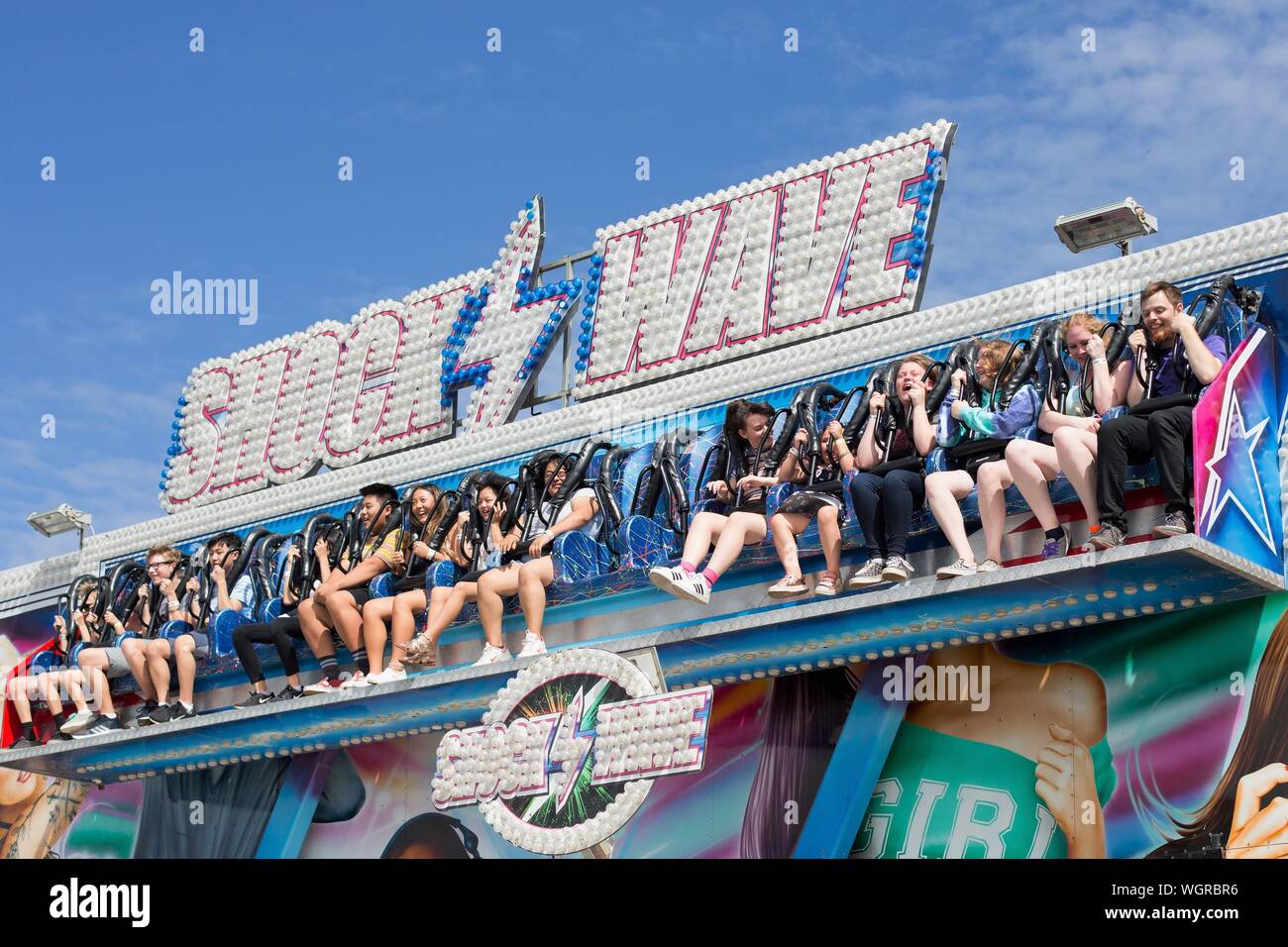 Excited faces of kids riding the Shock Wave at the Oregon State Fair in ...
