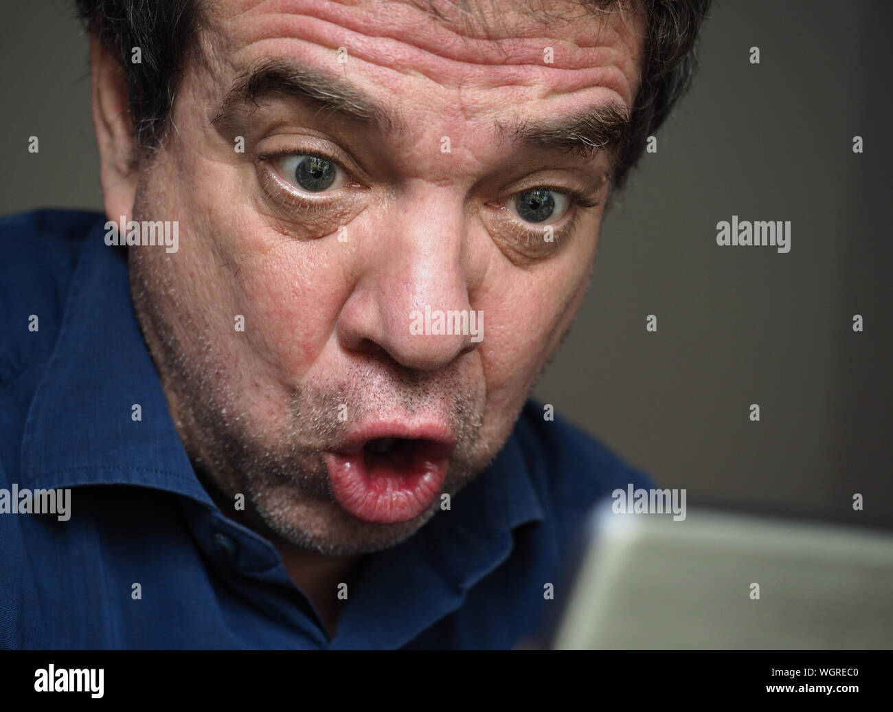 Mobile surprise man hi-res stock photography and images - Alamy