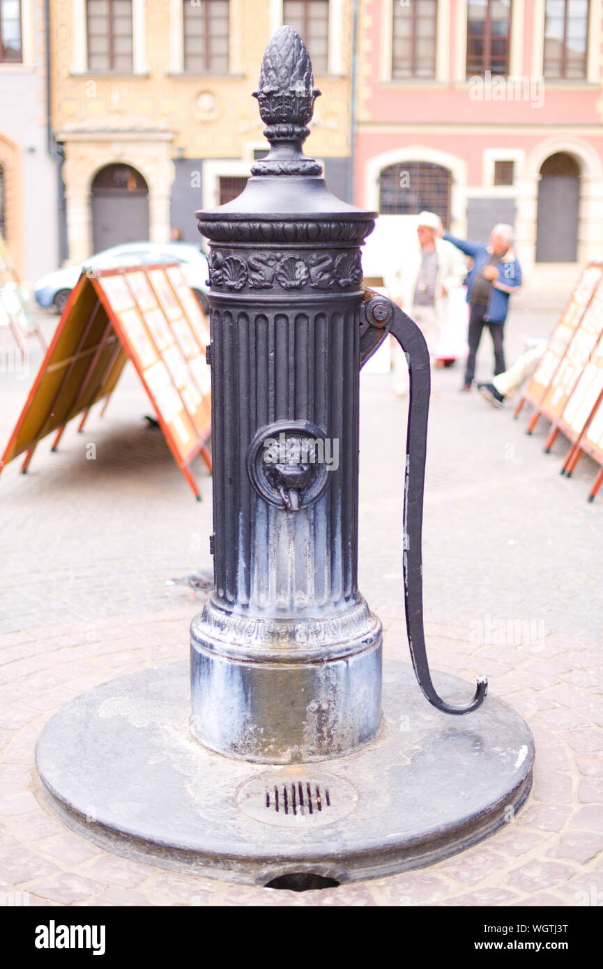 Traditional hand operated water pump in the old town market square in ...