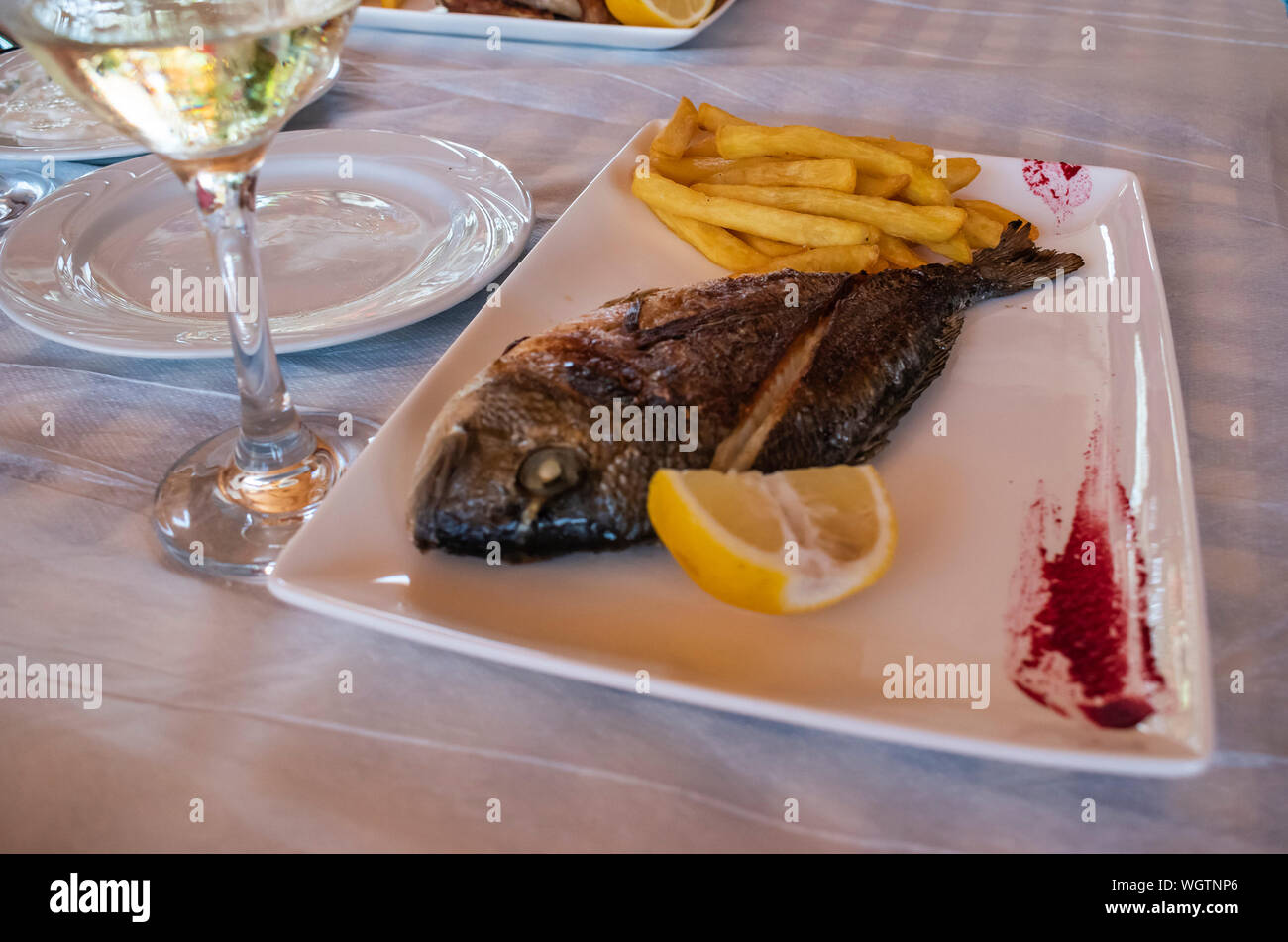 Grilled Gilt-head Beam fish served at an restaurant in Saranda coastal ...