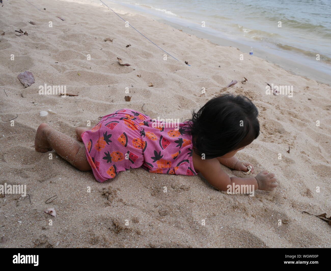 Girl lying in sand hi-res stock photography and images - Alamy