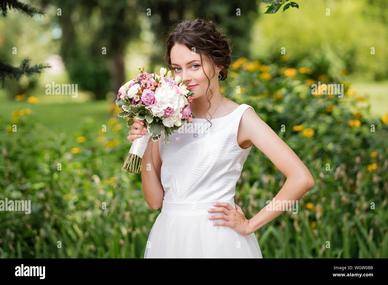 Beautiful bride in fashion wedding dress on natural background. The ...