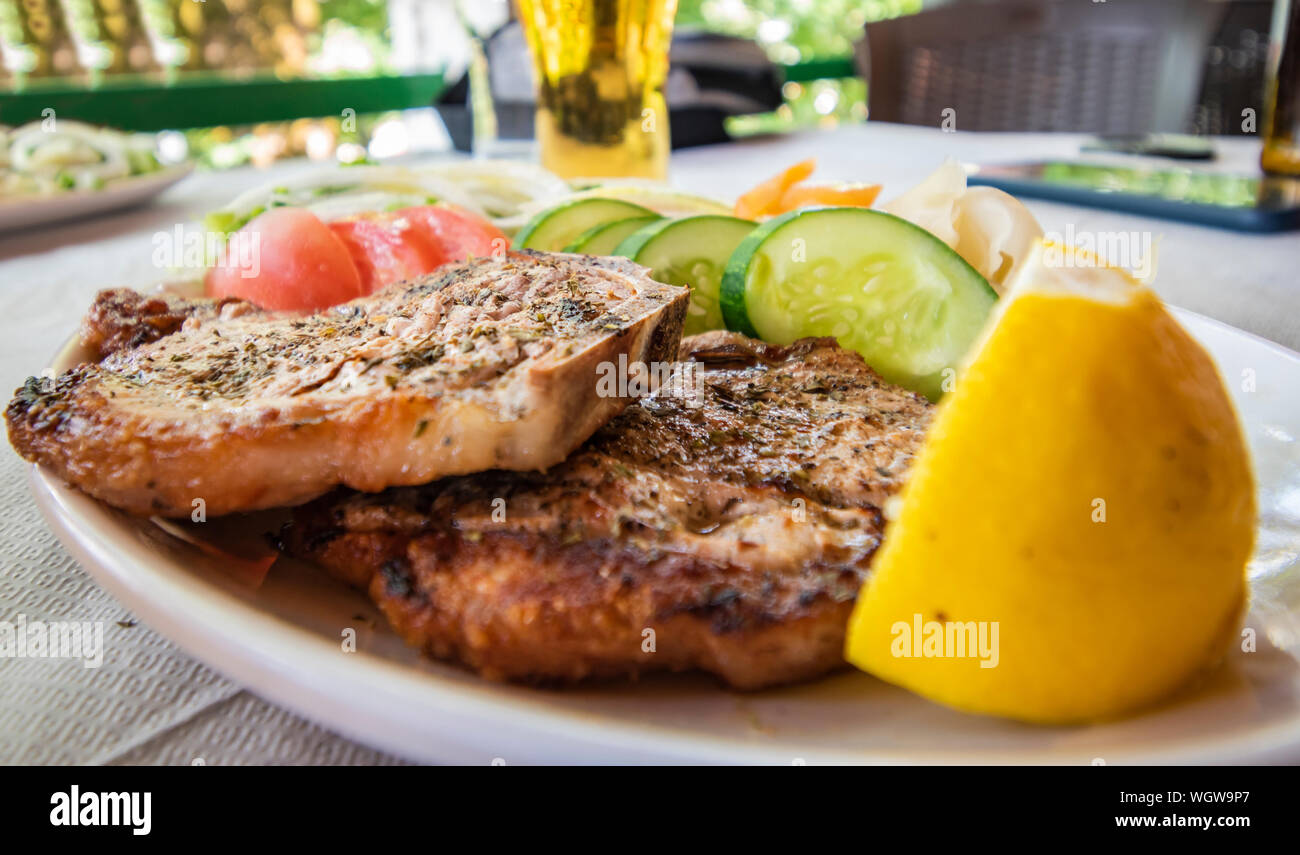 Grilled piglet meat served with vegetable (The Albanian Meze or ...