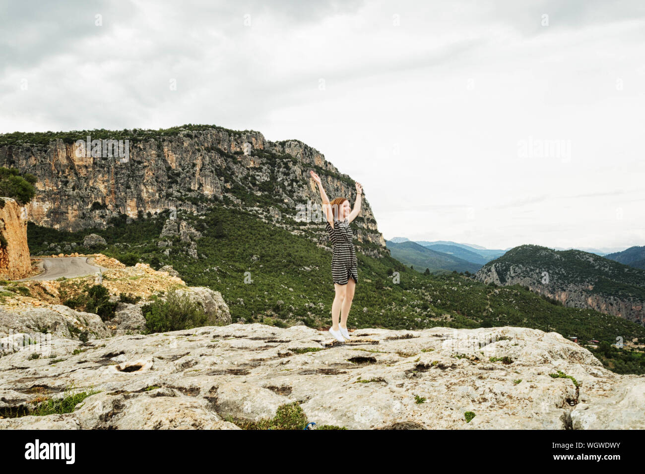 Woman jumping rock formation hi-res stock photography and images - Alamy