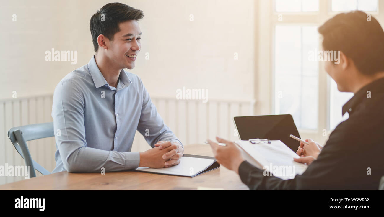 Professional businessman discussing the project with his coworker in ...