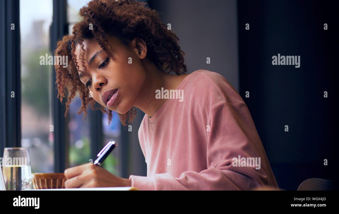 Black lady writing hi-res stock photography and images - Alamy