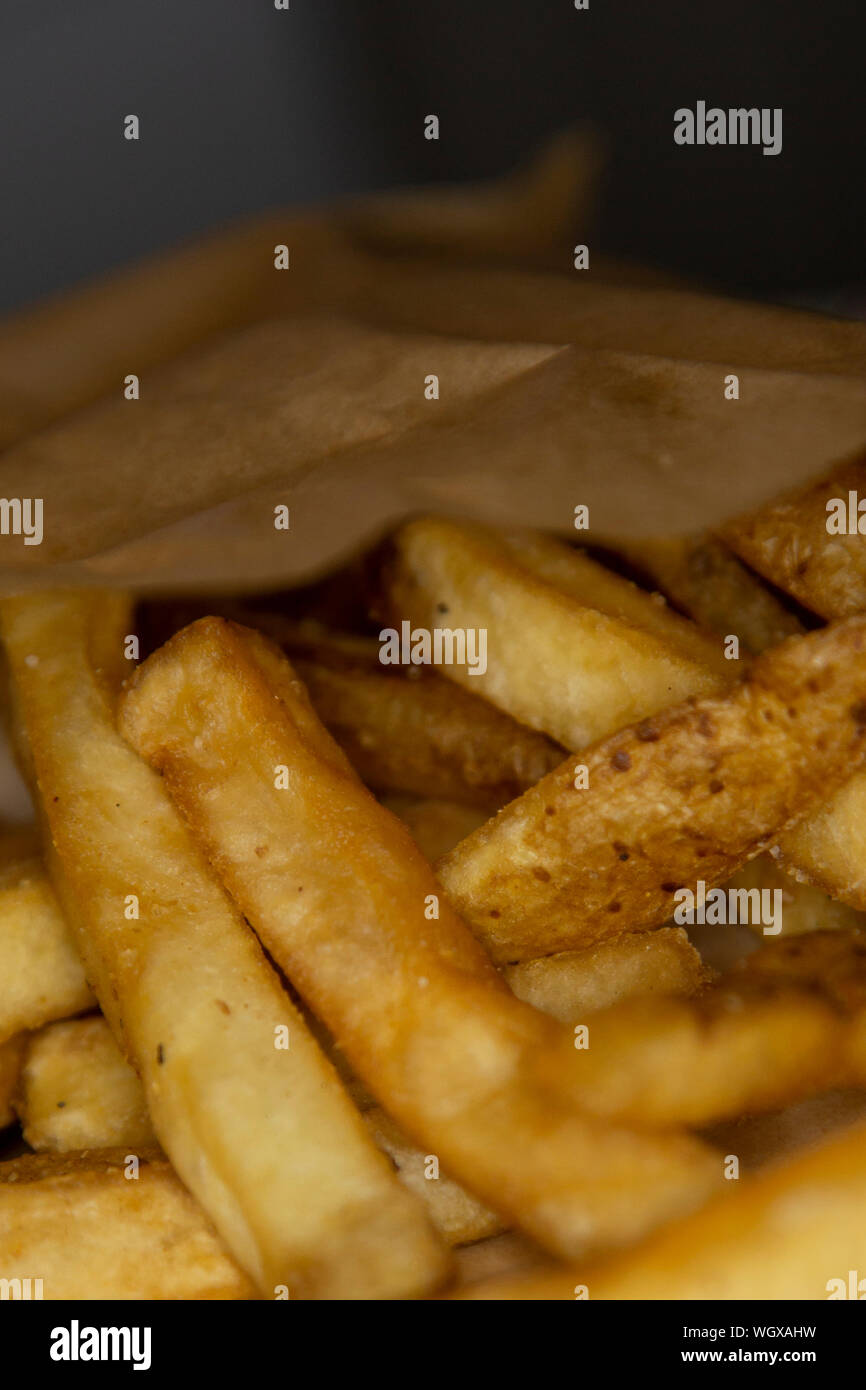 Golden fried french fries in brown paper wrapping Stock Photo - Alamy