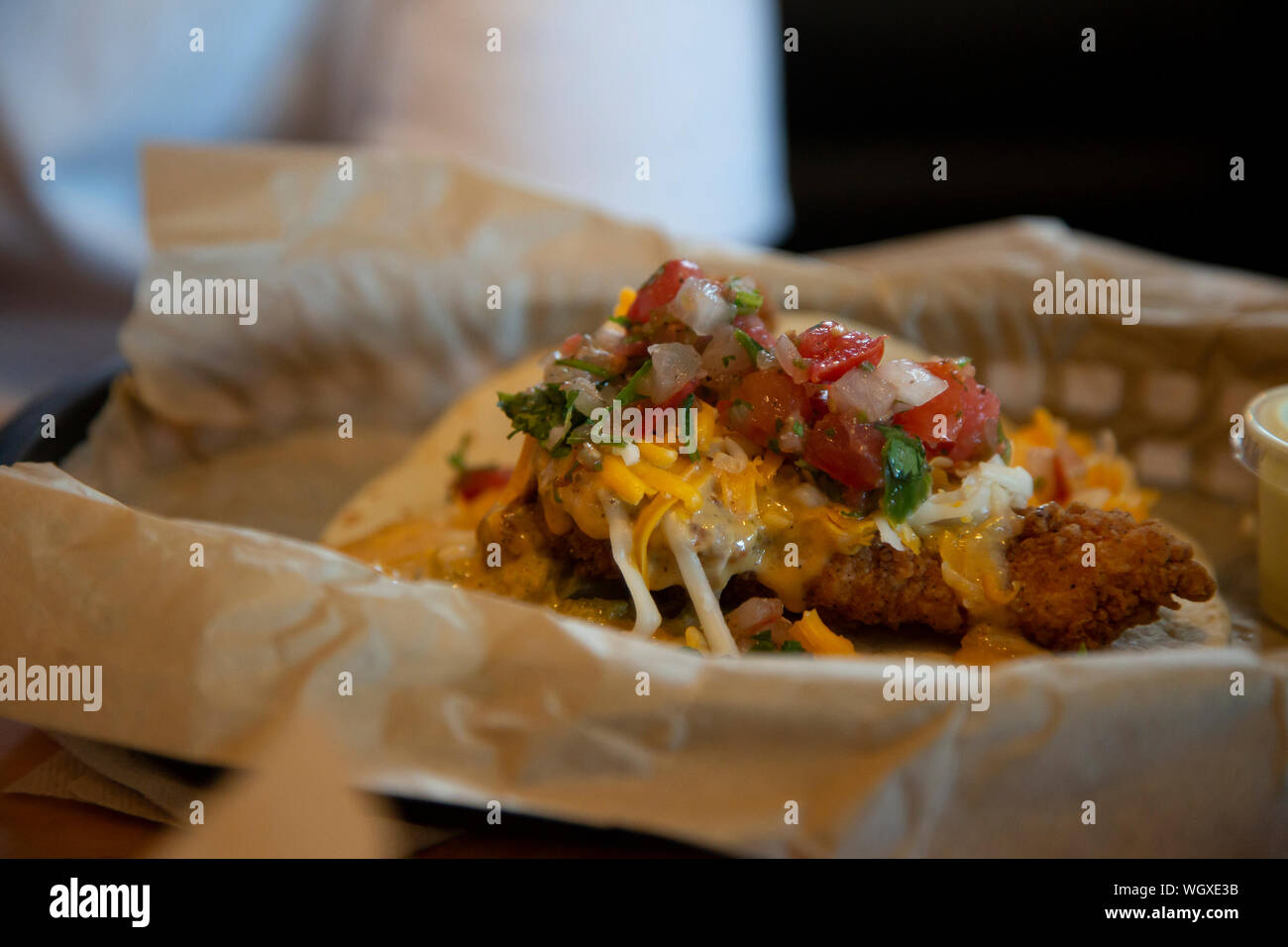 Fried chicken taco with pico de gallo, cheddar cheese, and a soft shell ...