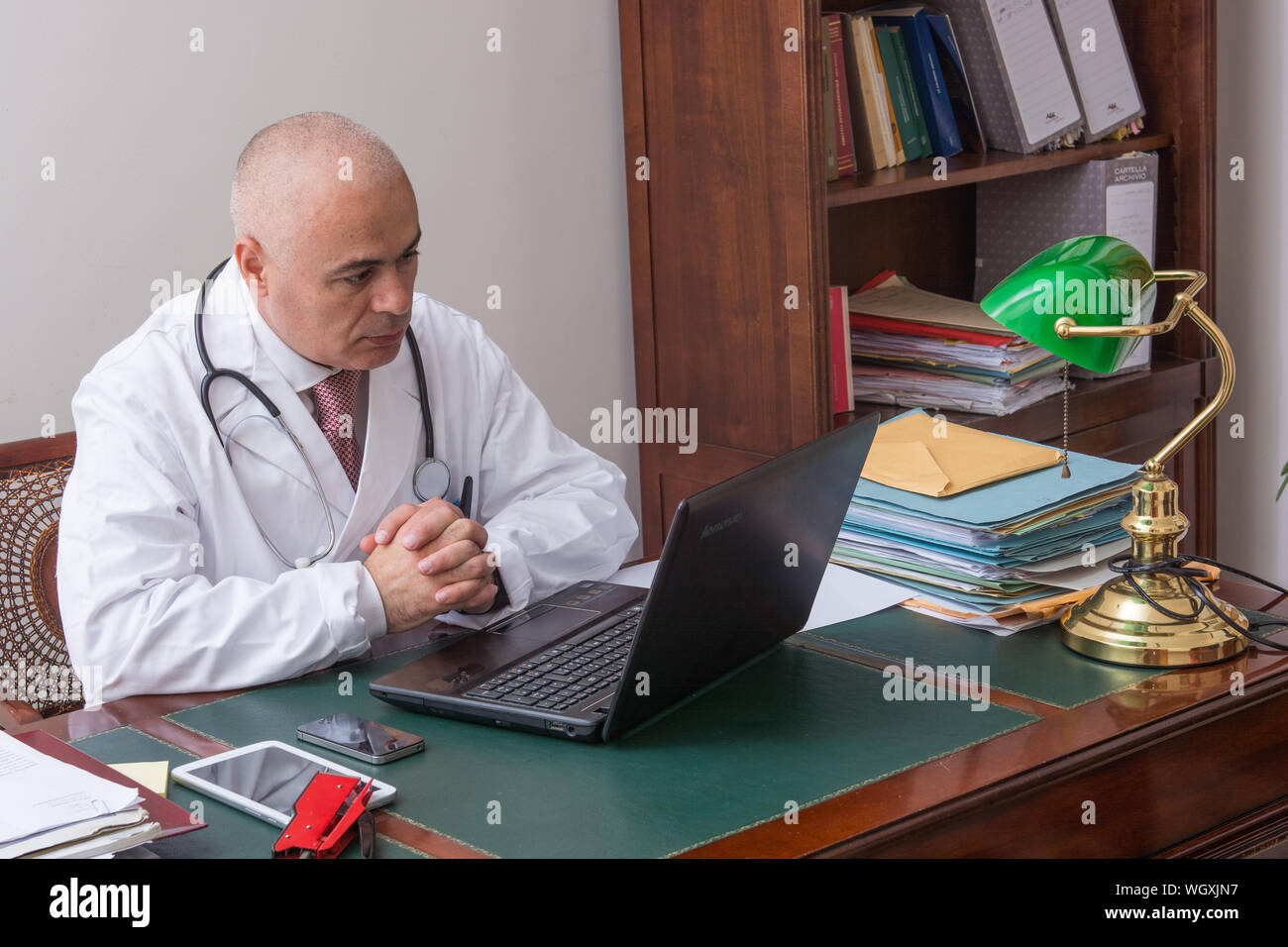 Doctor sitting on chair hi-res stock photography and images - Alamy