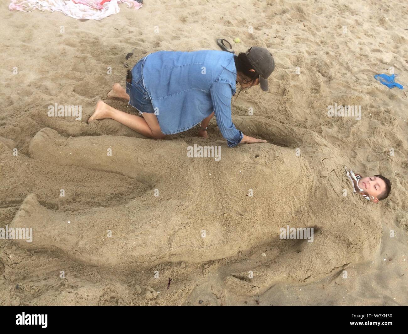 Buried Woman Sand High Resolution Stock Photography and Images - Alamy