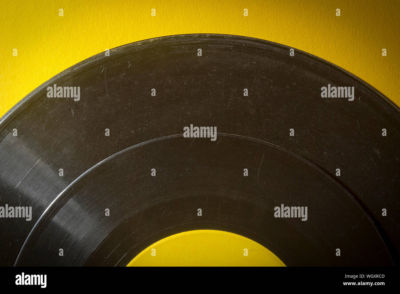 Vinyl record in an envelope on a yellow background Stock Photo - Alamy