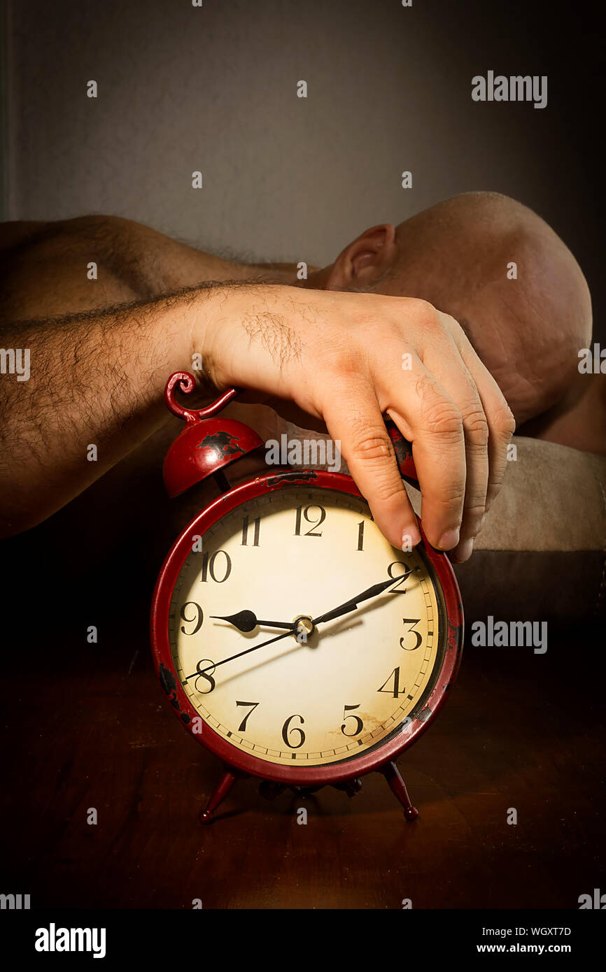 Sleepy man's hand turns off the alarm Stock Photo - Alamy