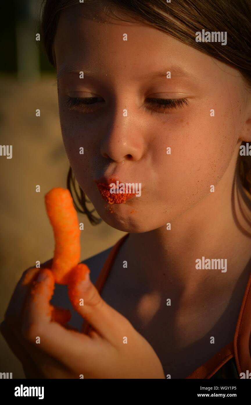 Girl eating snack hi-res stock photography and images - Alamy