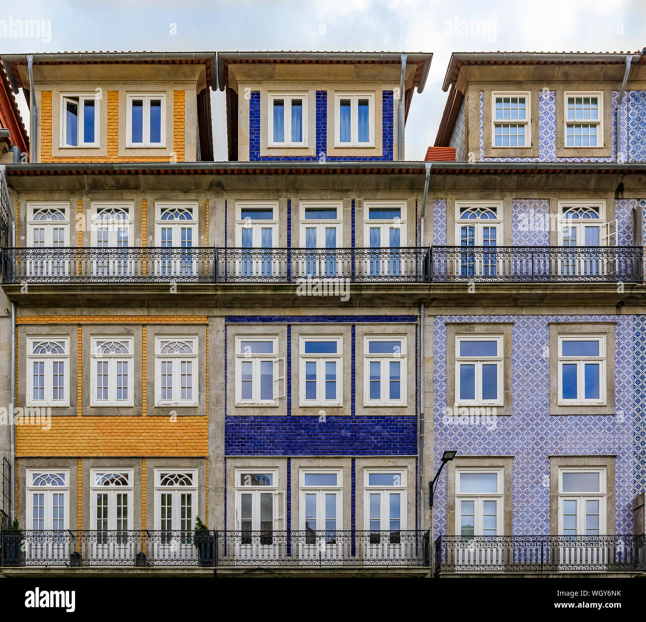 Facades of traditional houses decorated with ornate Portuguese azulejo ...