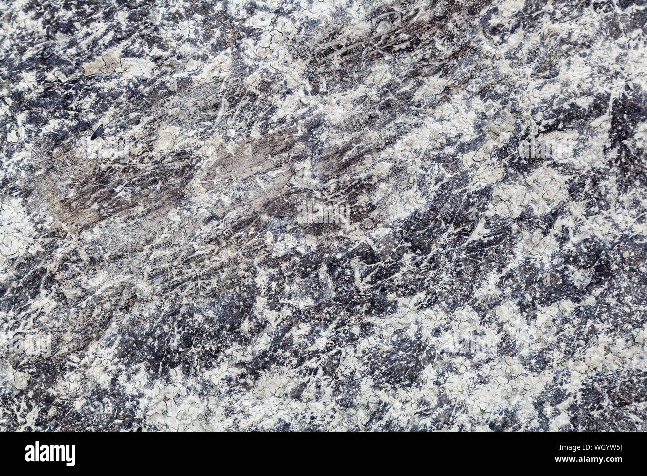 Close-up of a gray stone wall of a very old mountains. Gray texture ...