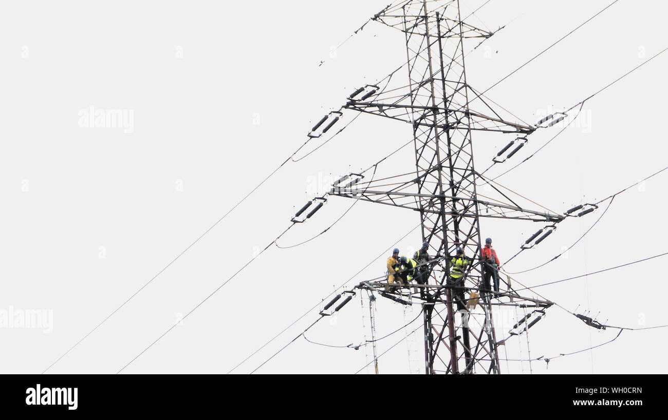 Men working on electricity pylon hi-res stock photography and images ...