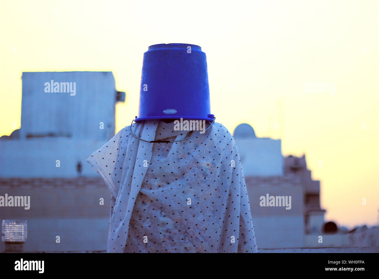 Woman with bucket on head hi-res stock photography and images - Alamy