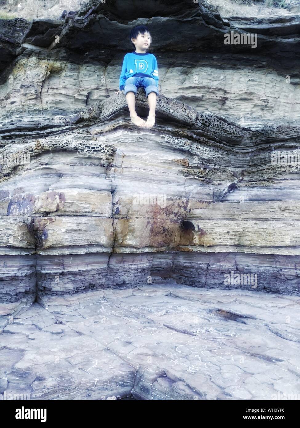 Boy sitting low angle hi-res stock photography and images - Alamy