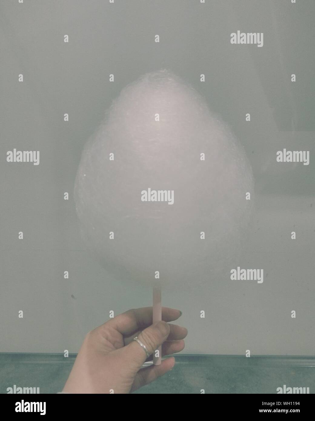 Hand holding candy hi-res stock photography and images - Alamy