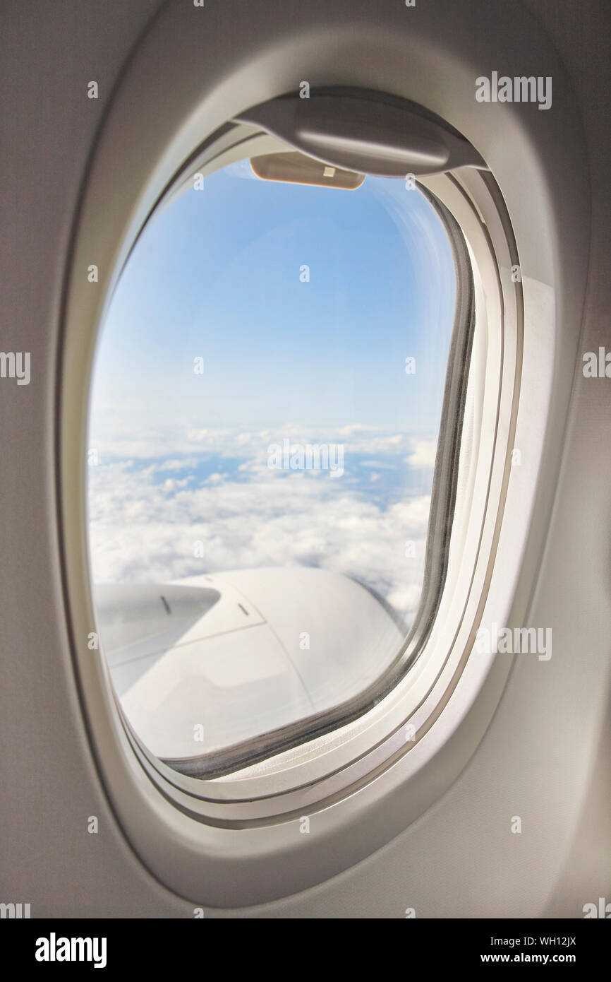 Open window with sky on a comercial aeroplane. Cabin interior. Vertical ...