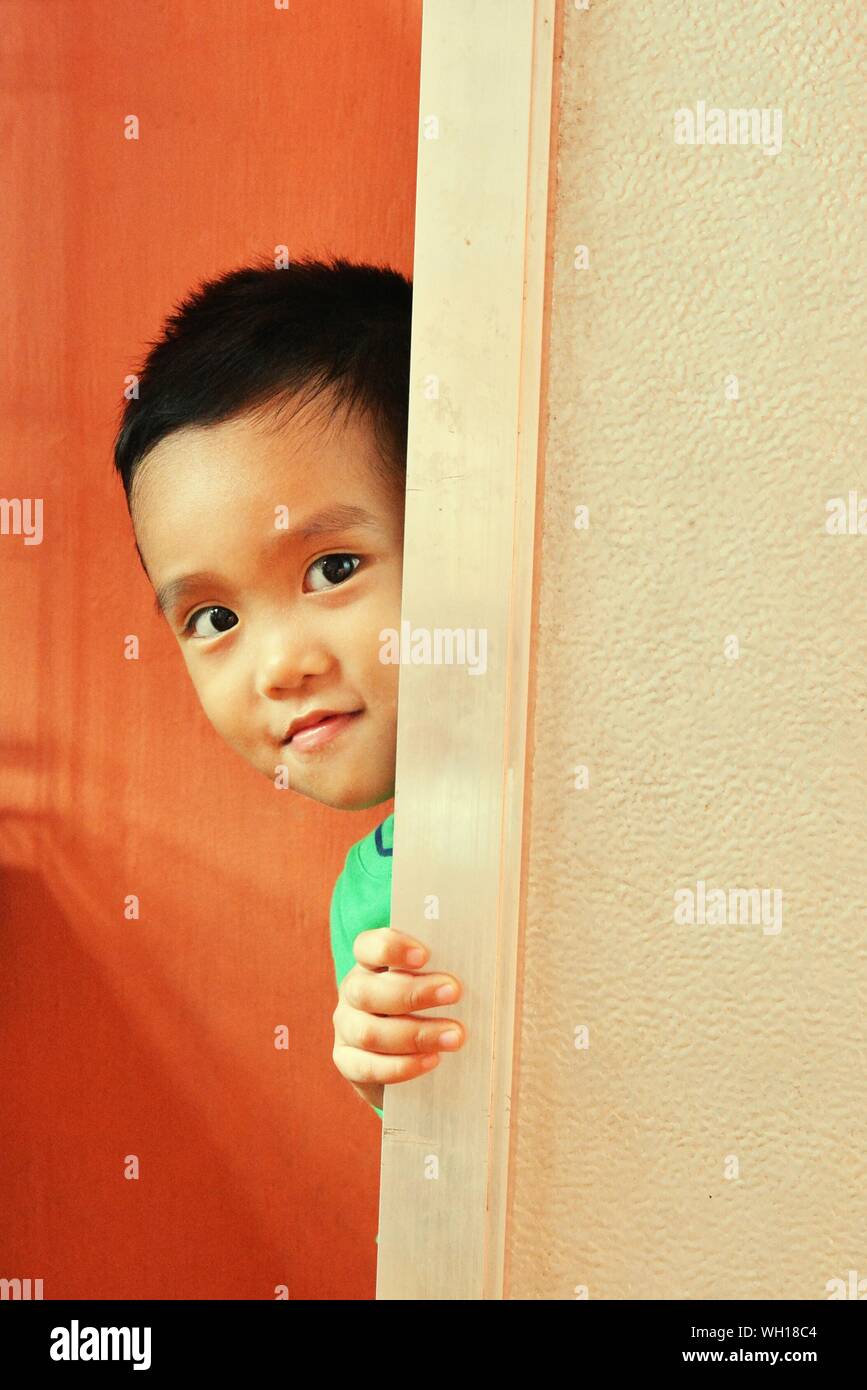 Boy Hiding Behind Wall High Resolution Stock Photography and Images - Alamy