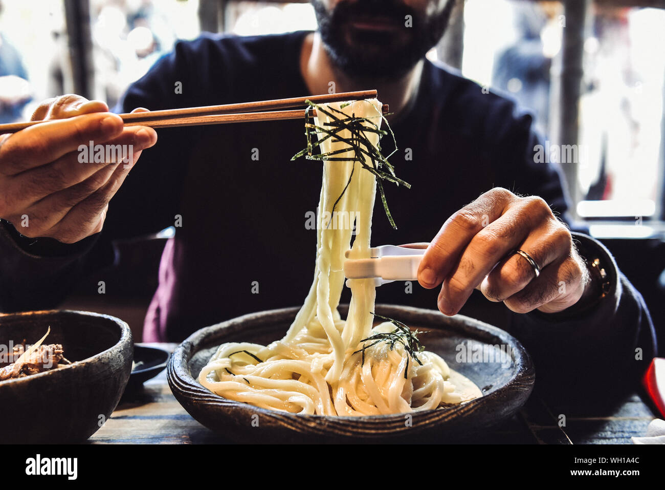 Man eating noodles restaurant hi-res stock photography and images - Alamy