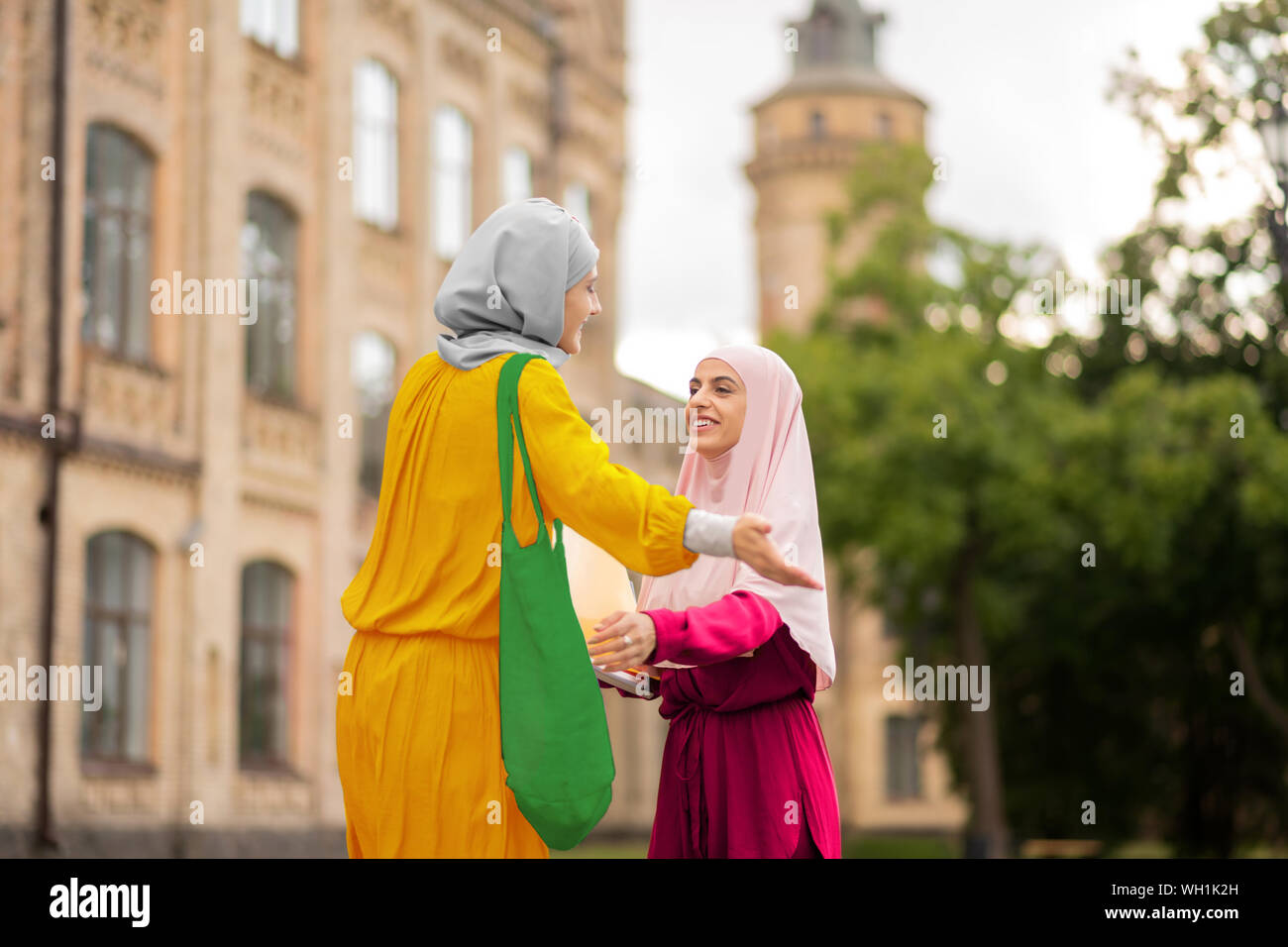 International muslim students smiling while meeting near university ...