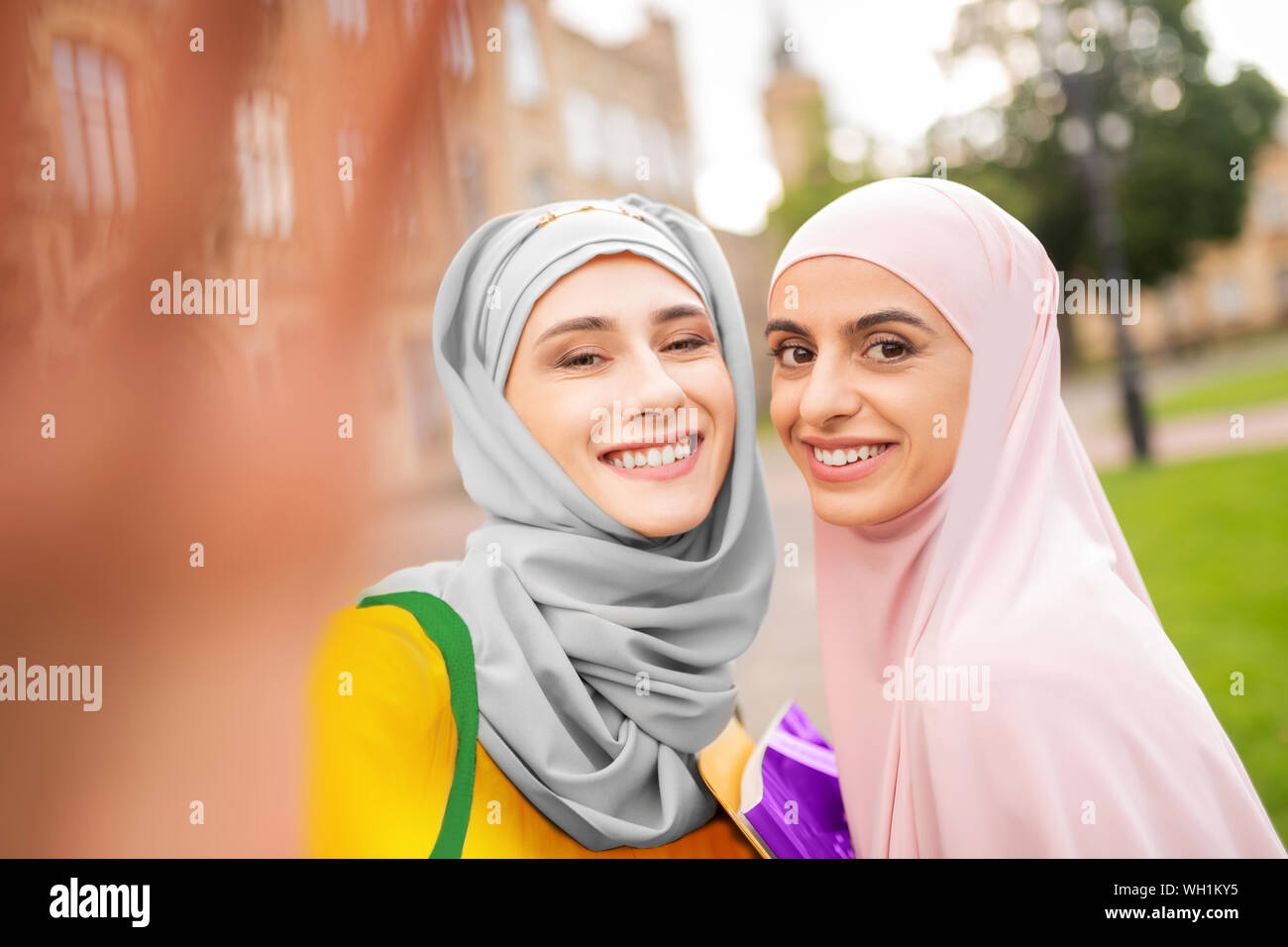 Female muslim students wearing hijabs smiling broadly Stock Photo - Alamy