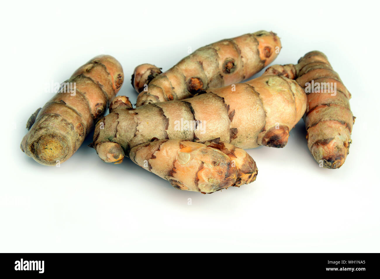 Fresh turmeric powder in a bowl and turmeric root, Indian spices an ...