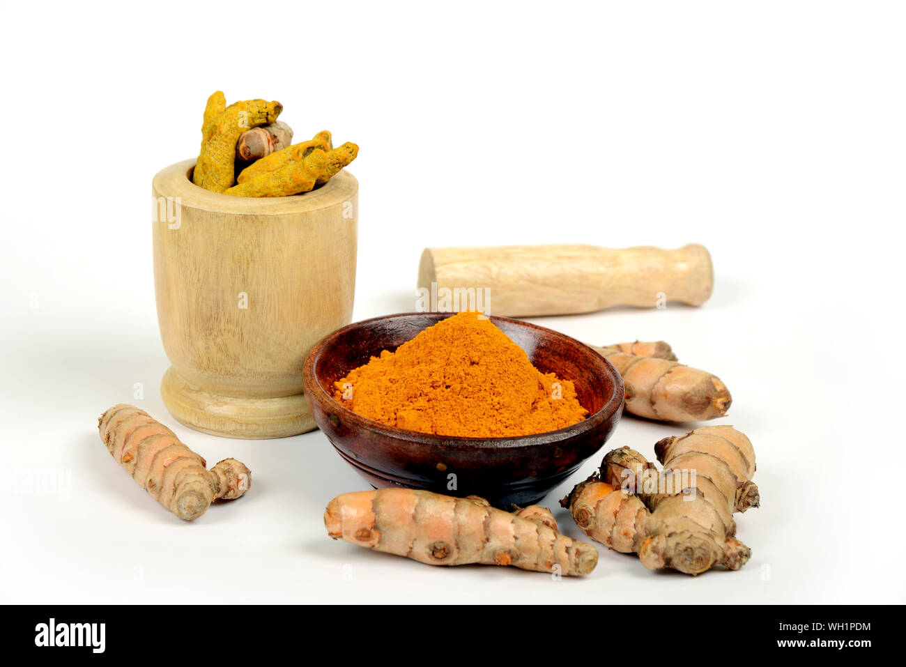 Fresh turmeric powder in a bowl and turmeric root, Indian spices an ...