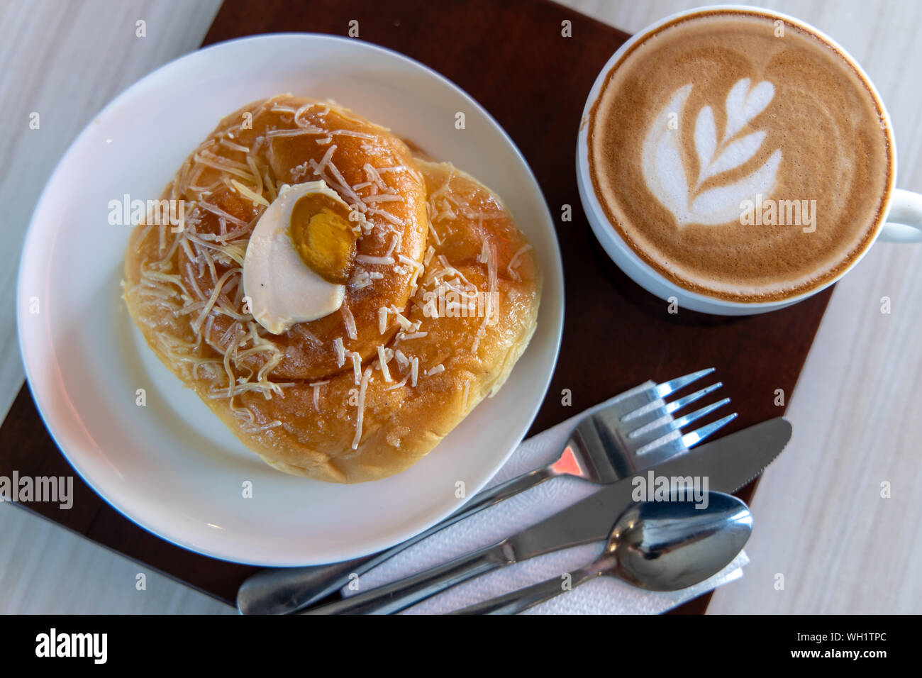 Filipino traditional desert Ensaymada with cafe latte, Philippines ...