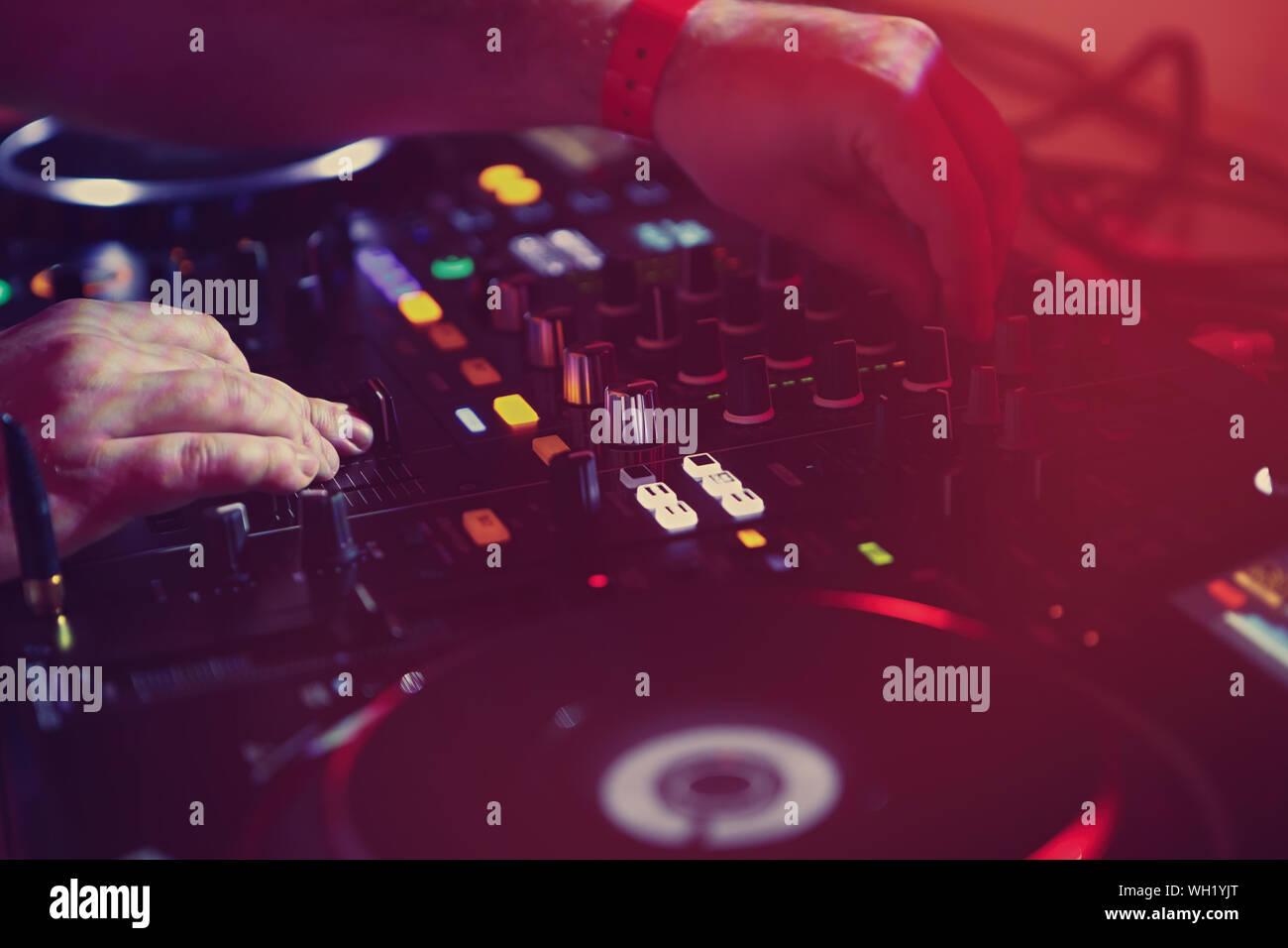 Hands of concert dj mixing musical tracks on stage.Disc jockey ...