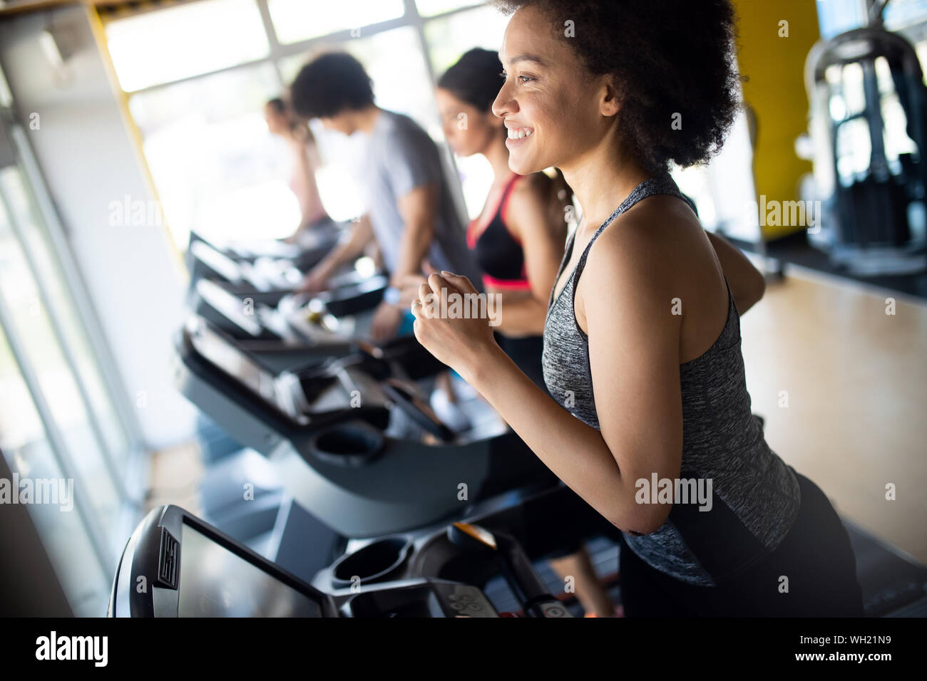 Beautiful fit people exercising together in gym Stock Photo - Alamy