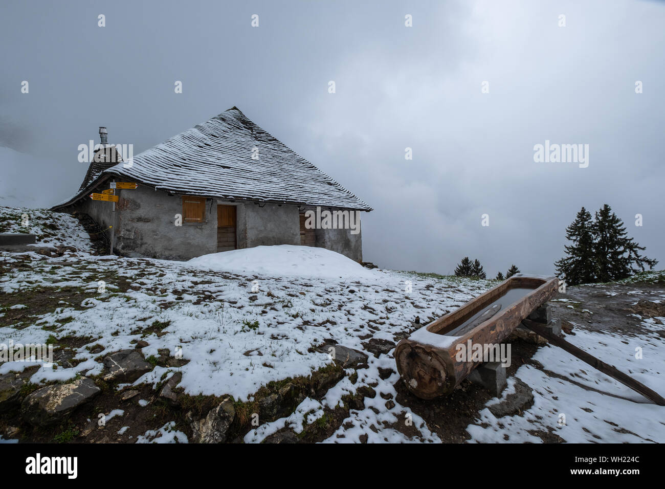 Chalet in Switzerland Alps mountains in winter, fog Stock Photo - Alamy