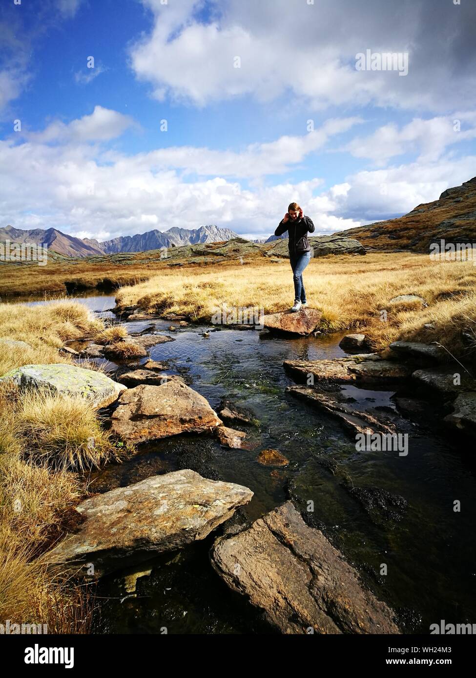 Person crossing the stream hi-res stock photography and images - Alamy