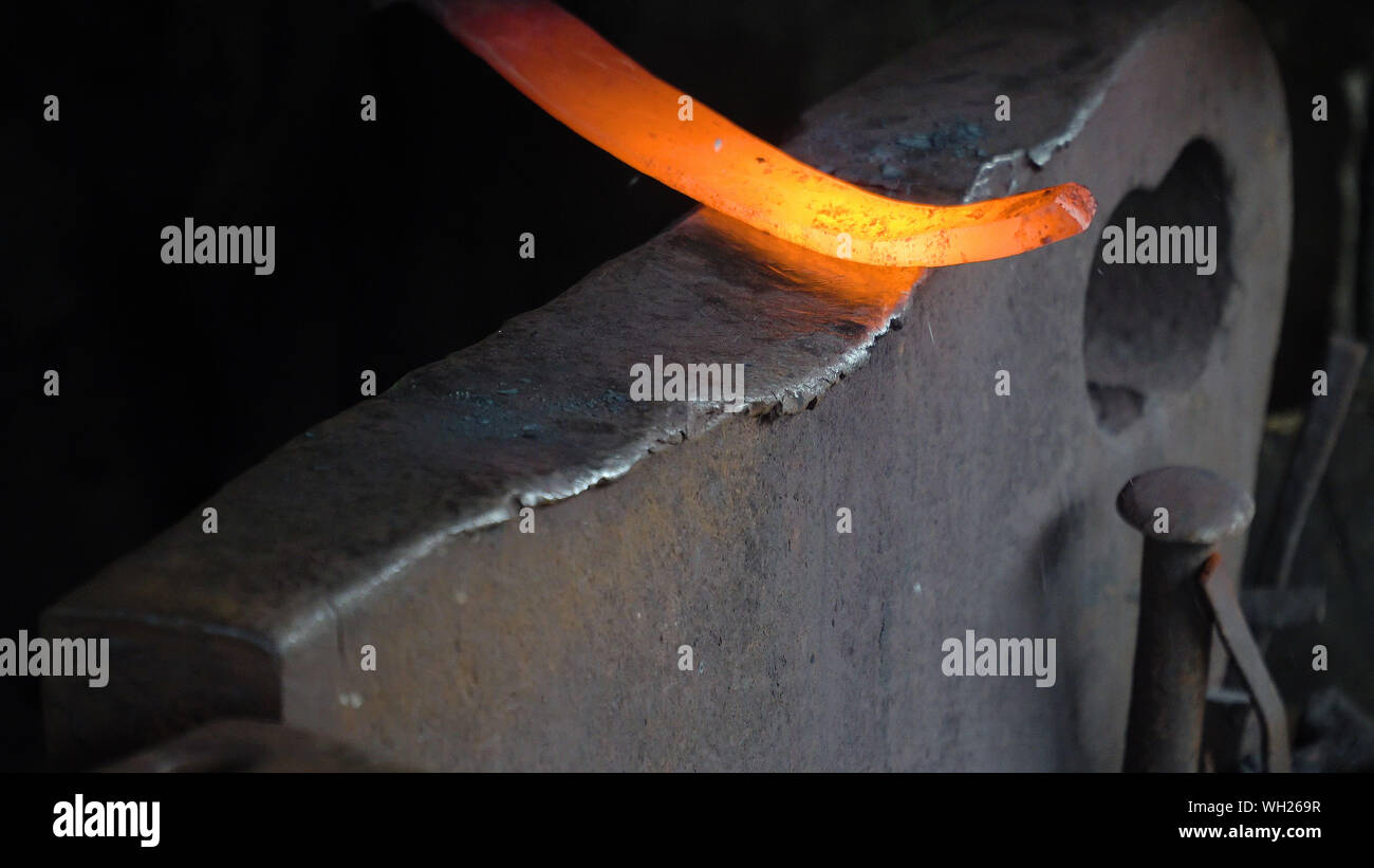 Hot metal on the anvil in the forge. Anvil in the forge Stock Photo - Alamy