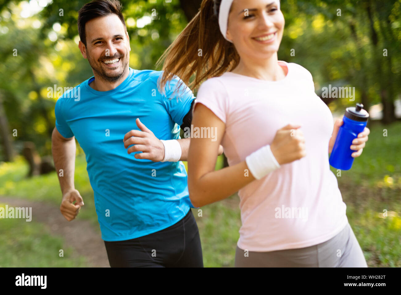 Young fitness couple running forest hi-res stock photography and images ...