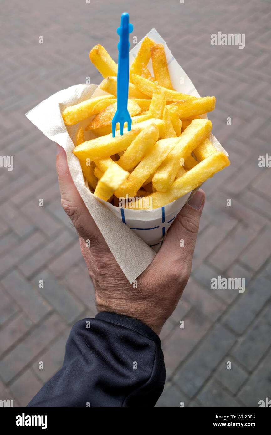 Dutch fries held in hand Stock Photo - Alamy
