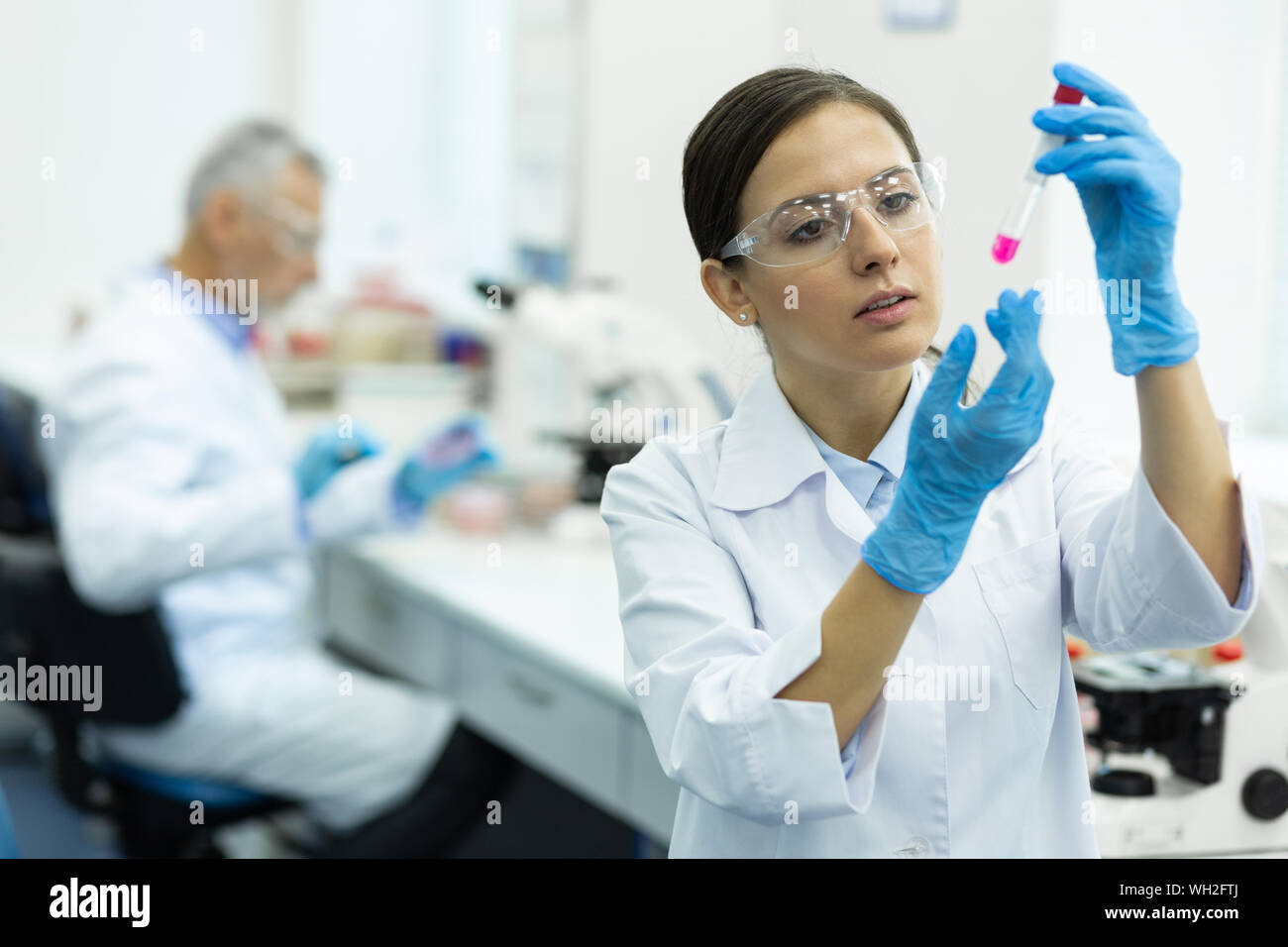 Serious young scientist doing chemical experiment in lab Stock Photo ...