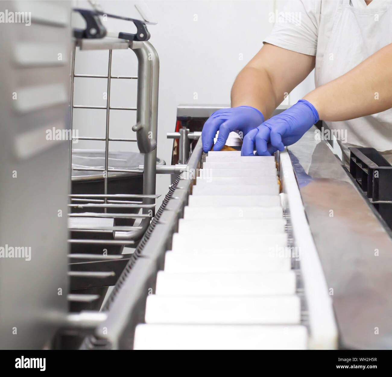Making and filling custard cakes with cream on a modern automatic line ...