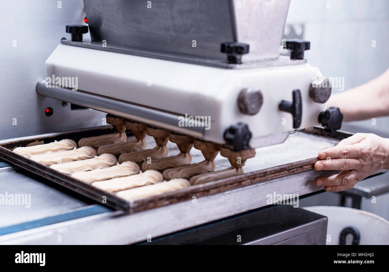 Automatic line for the production of eclairs. Eclair Cake Dough Baking ...
