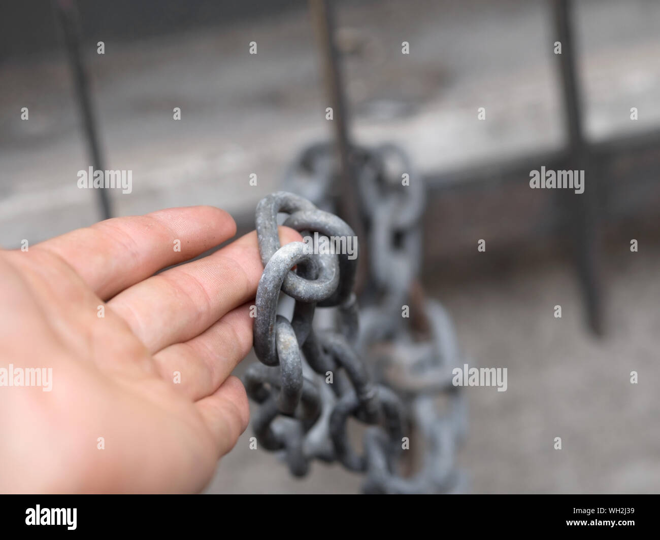 Human hand holding chain hi-res stock photography and images - Alamy