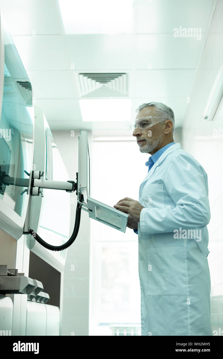 Serious senior scientist staring at screen of computer Stock Photo - Alamy
