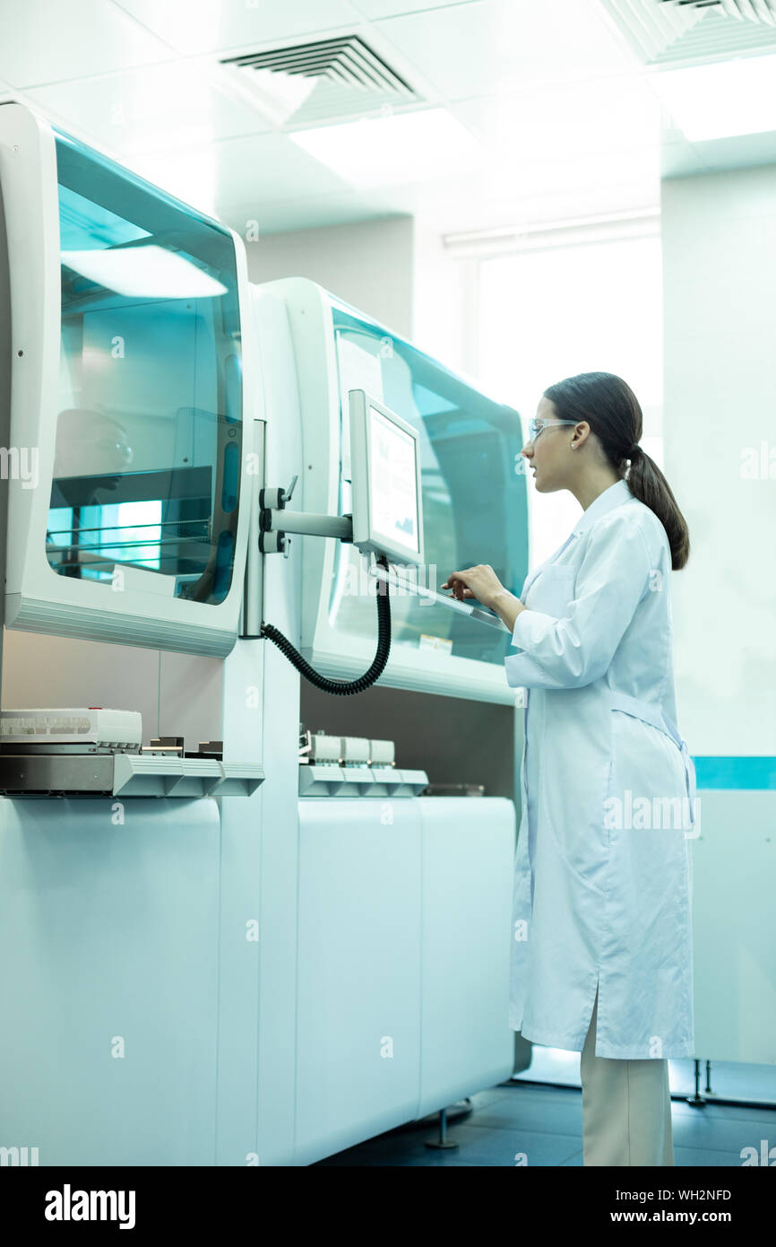 Concentrated young medical worker testing computer in lab Stock Photo ...