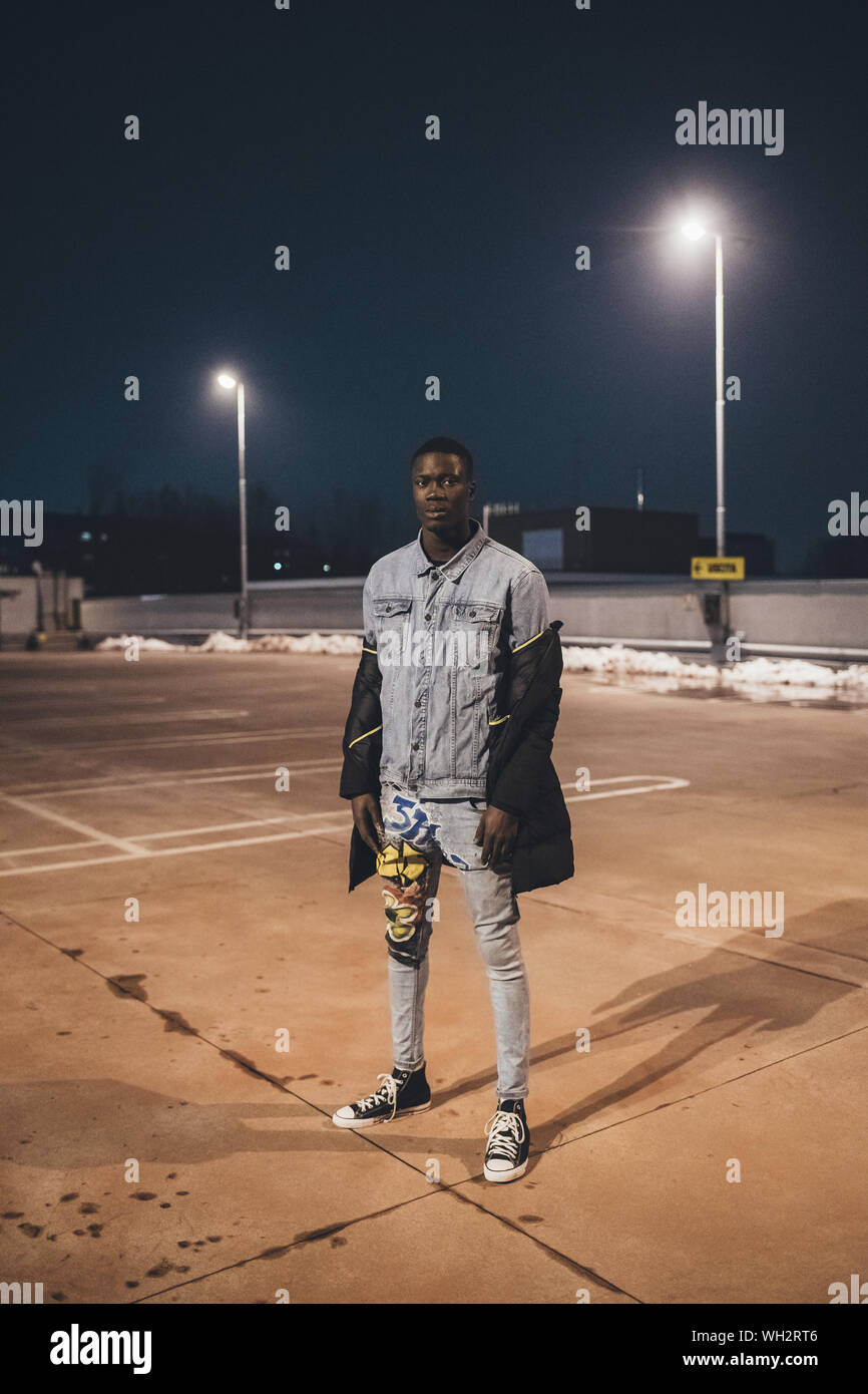 young black man standing outdoor in parking space – youth culture ...